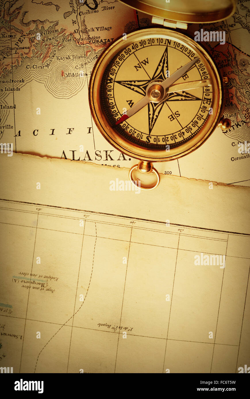Antique brass compass over old map Stock Photo - Alamy
