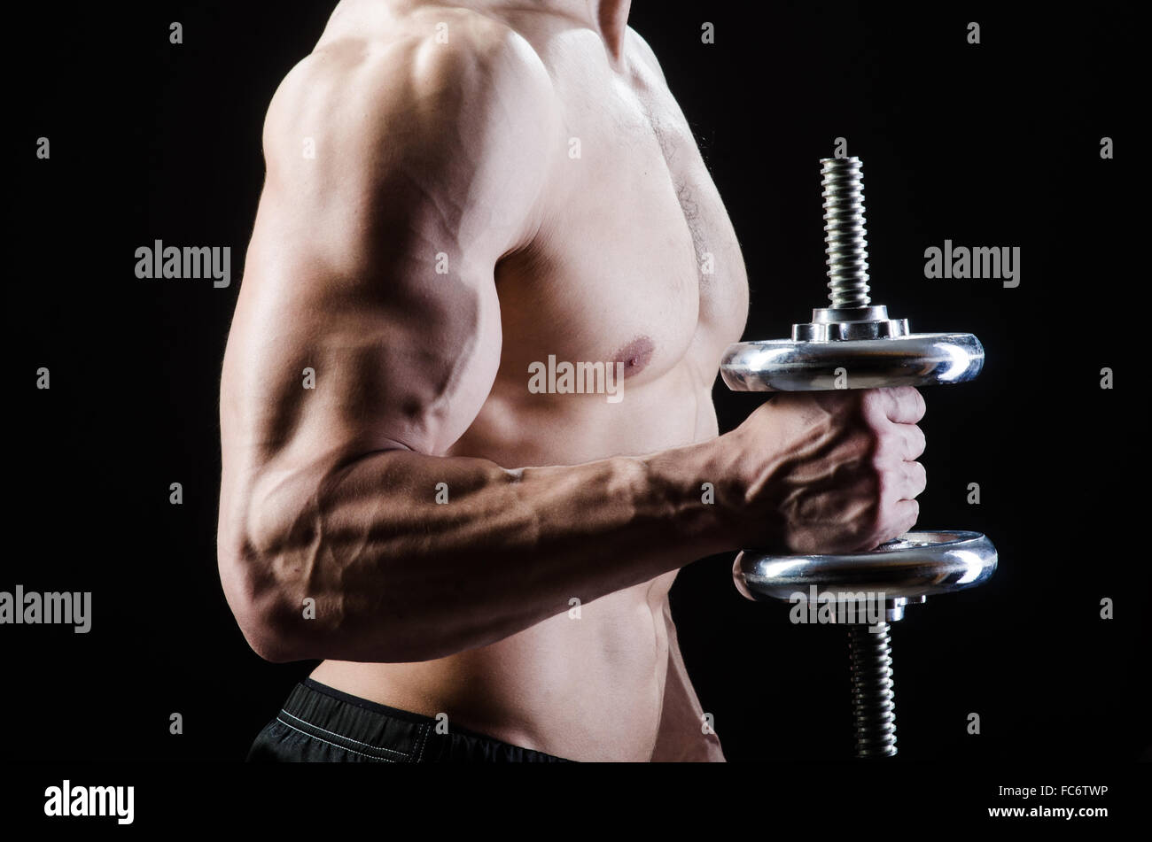 Muscular ripped bodybuilder with dumbbells Stock Photo - Alamy