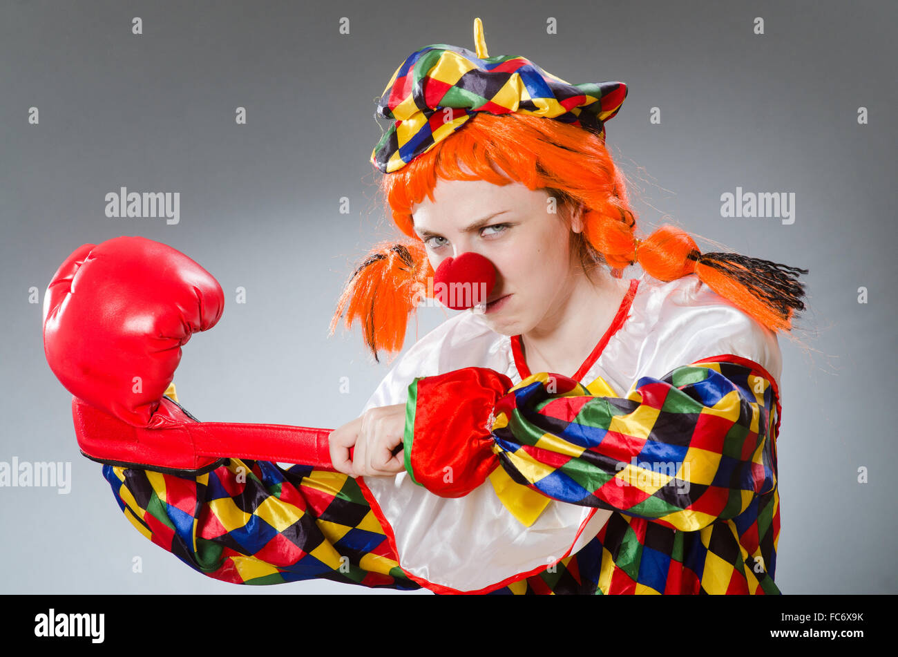 Clown with boxing gloves isolated on white Stock Photo - Alamy
