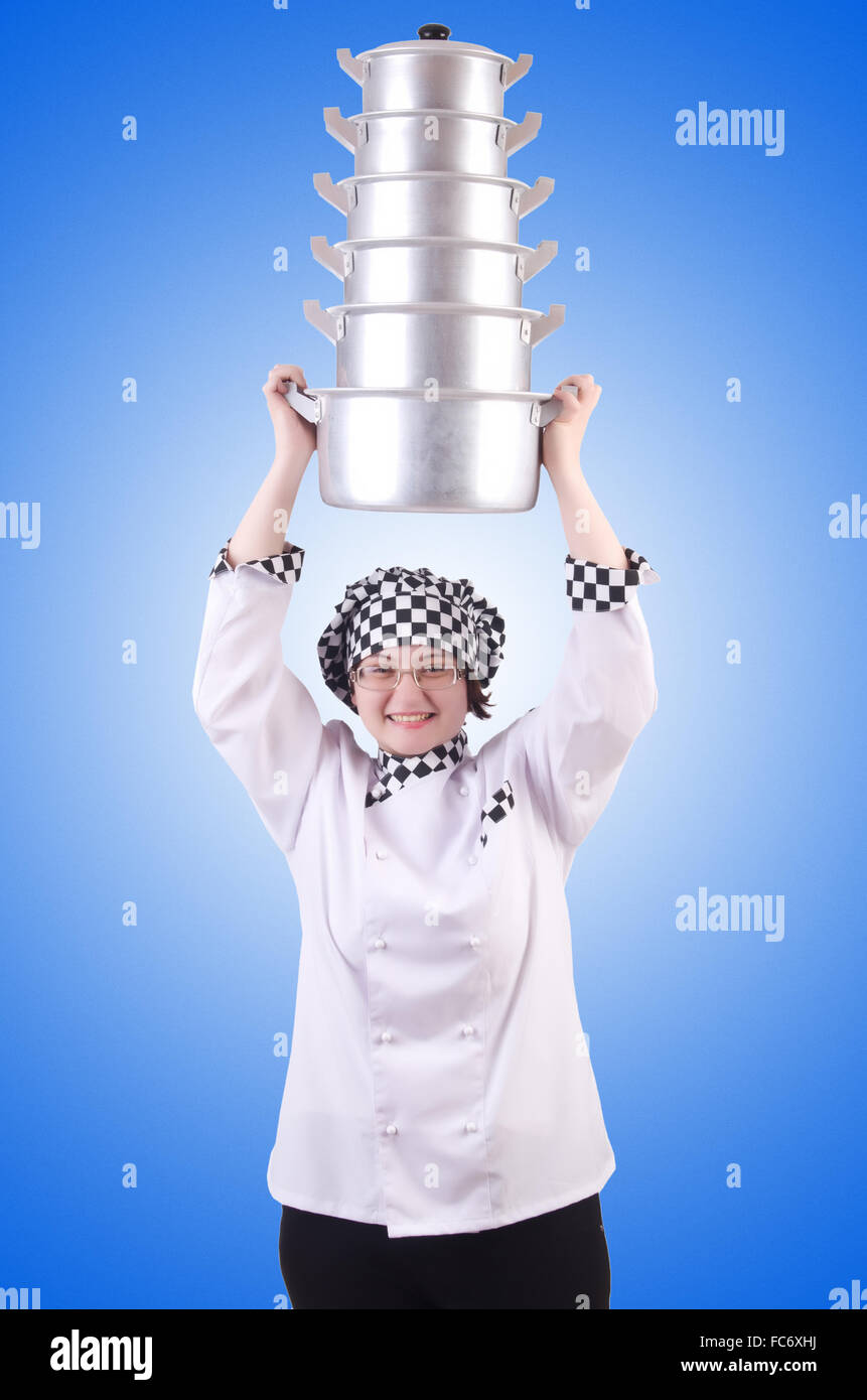Cook with stack of pots on white Stock Photo - Alamy
