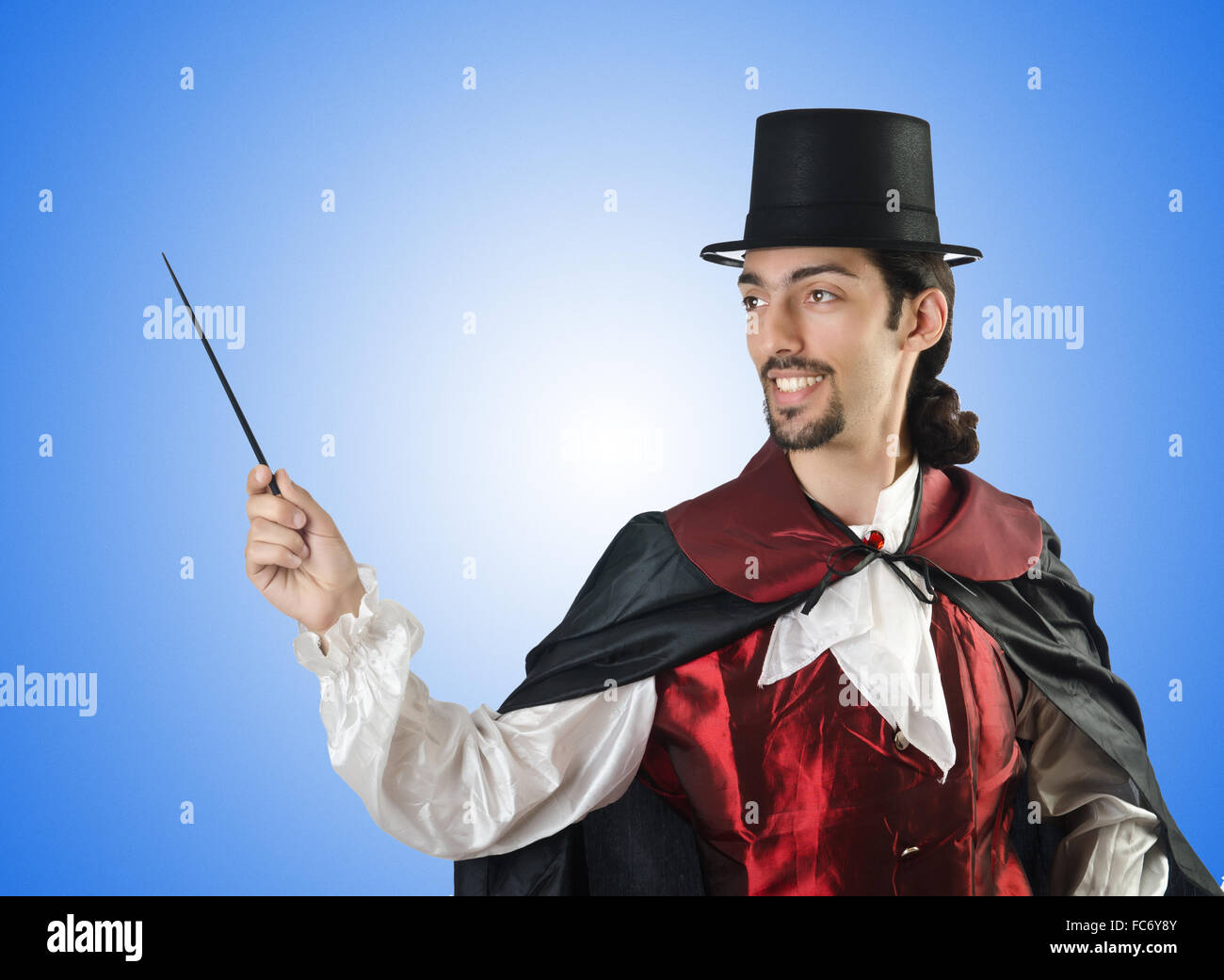 Magician doing tricks on white Stock Photo - Alamy