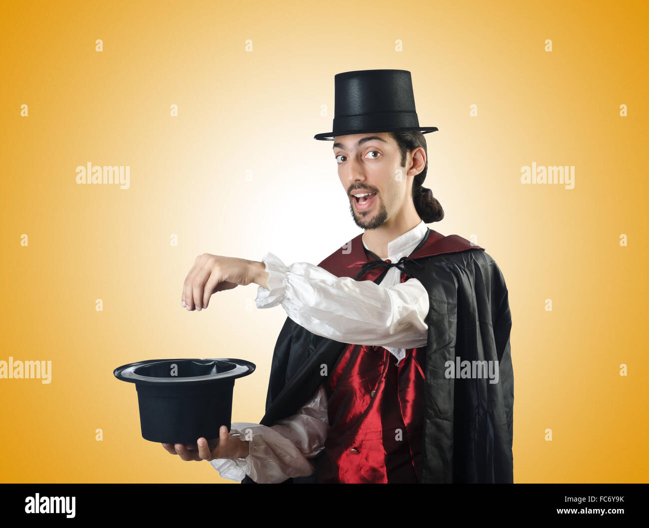 Magician doing tricks on white Stock Photo - Alamy