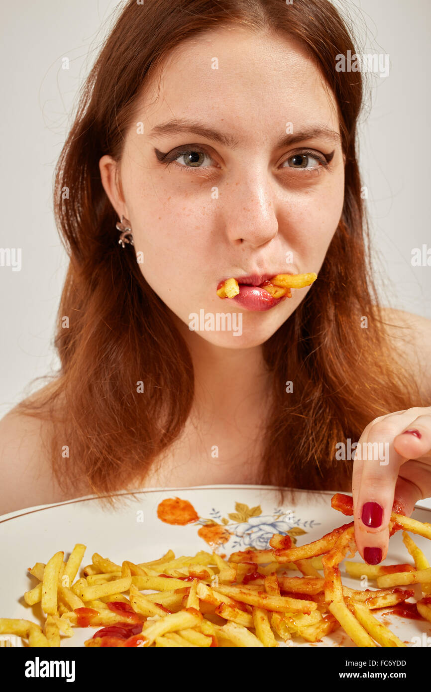 Young woman eating chips fries snack lunch hi-res stock photography and ...