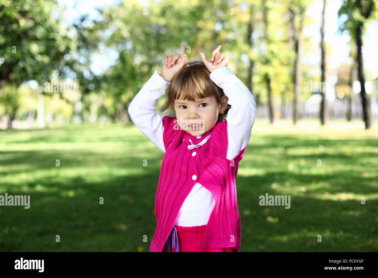 Little happy girl having fun in green summer park Stock Photo - Alamy