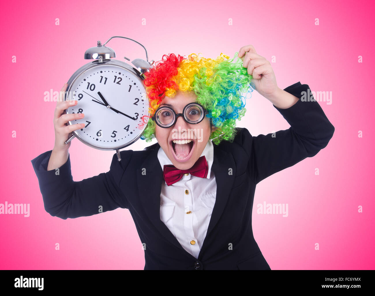 Funny clown with clock on white Stock Photo - Alamy