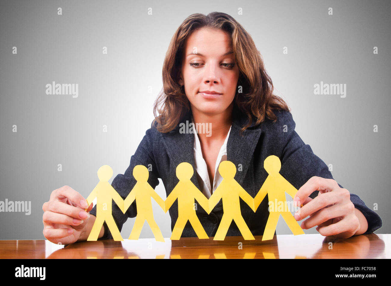 Woman with paper cut people Stock Photo - Alamy