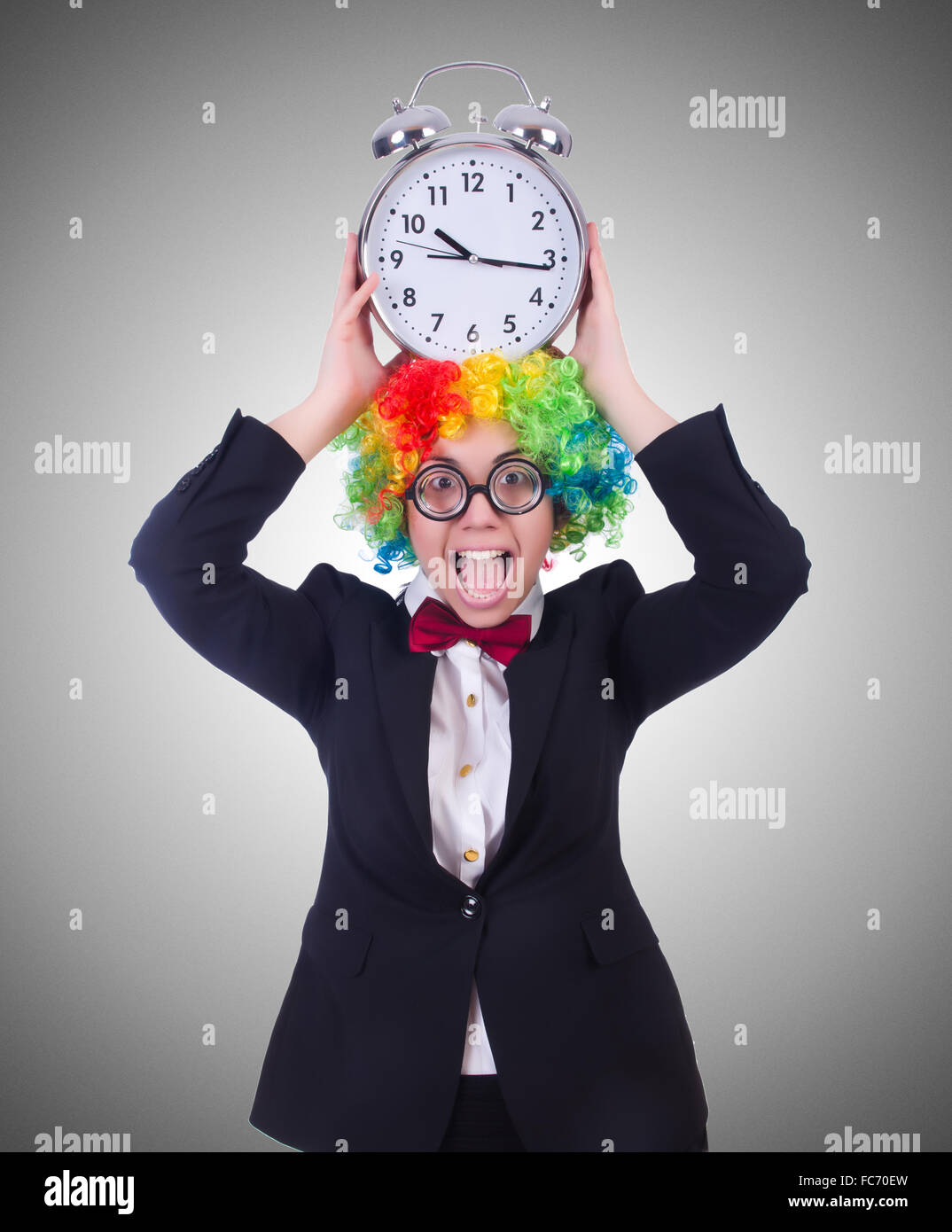 Funny clown with clock on white Stock Photo - Alamy