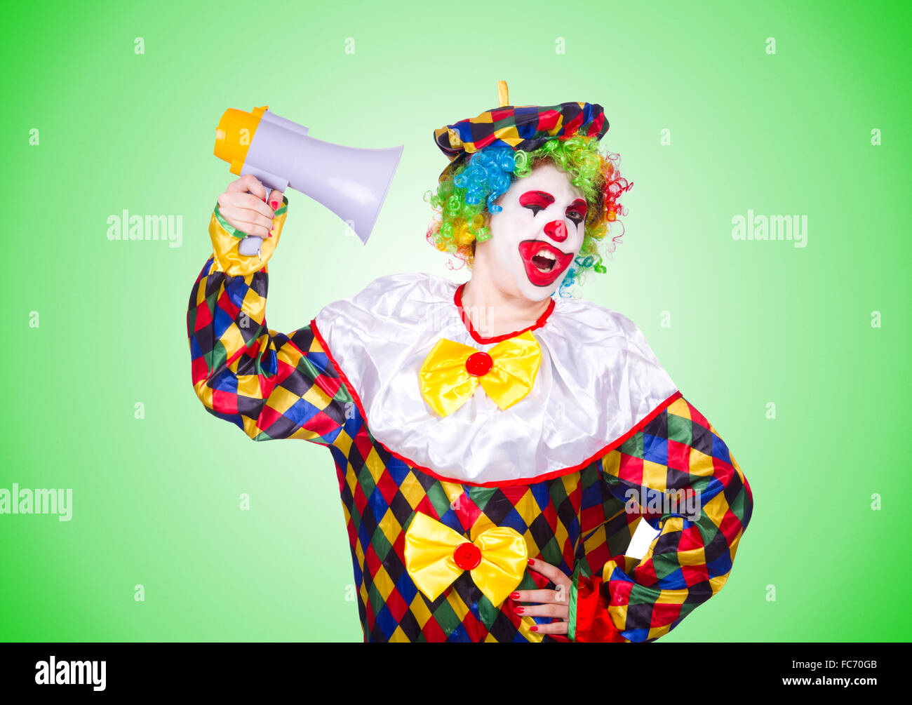 Clown with loudspeaker on white Stock Photo - Alamy