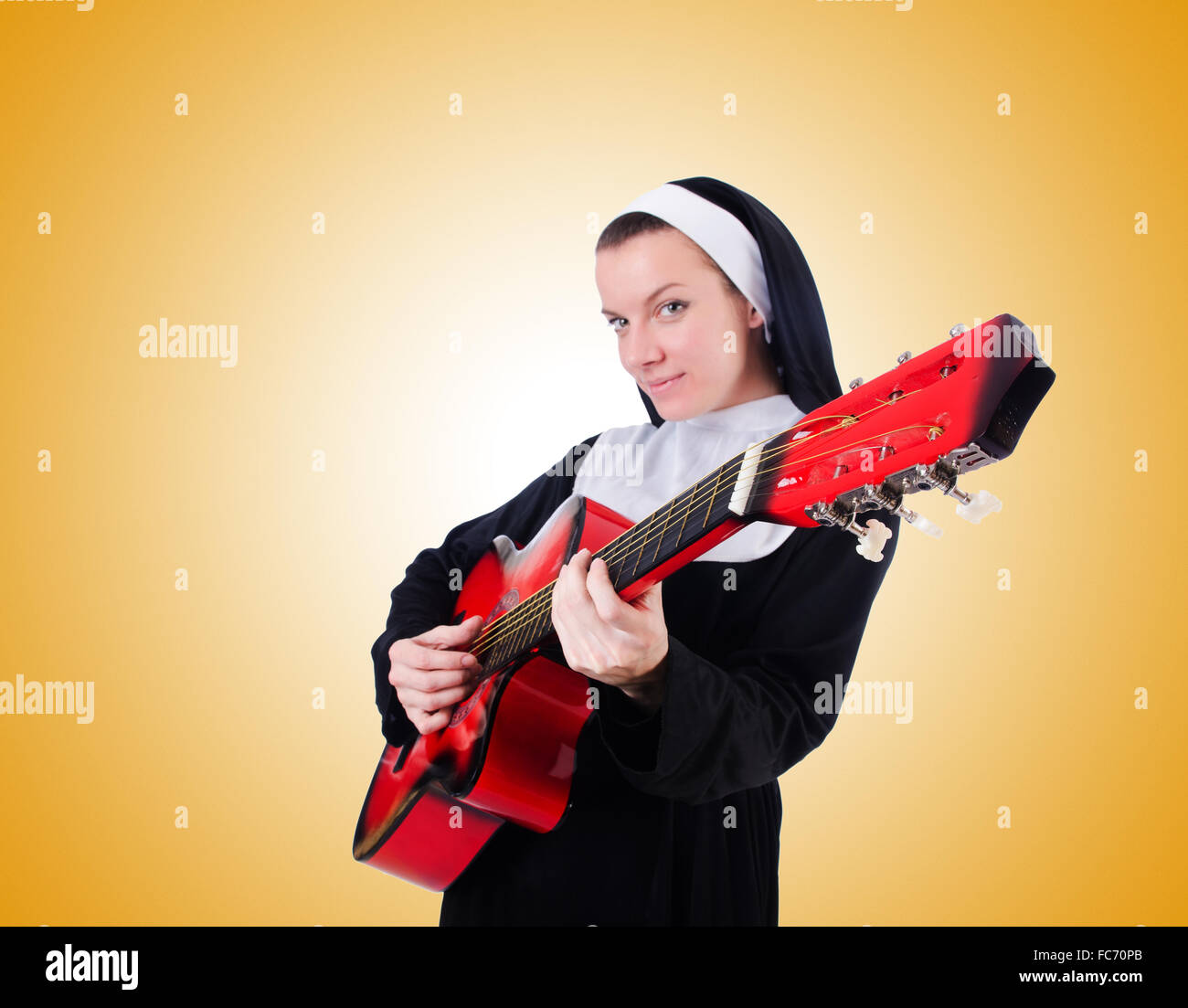 Nun playing guitar against the gradient Stock Photo - Alamy