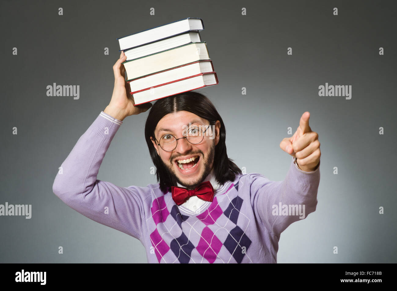Young student with book in learning concept Stock Photo - Alamy