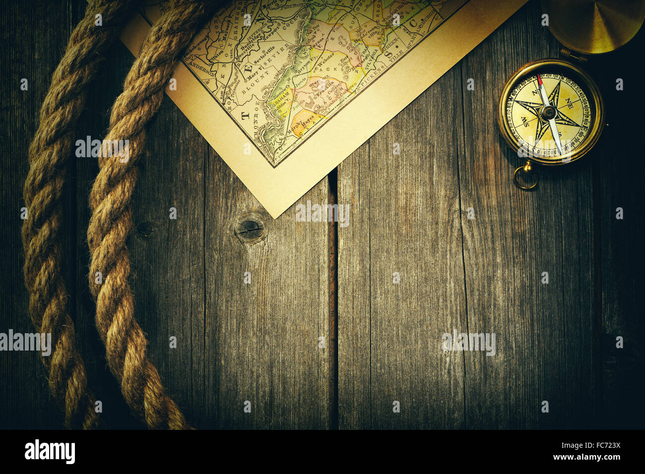 Antique compass and rope over old map Stock Photo - Alamy