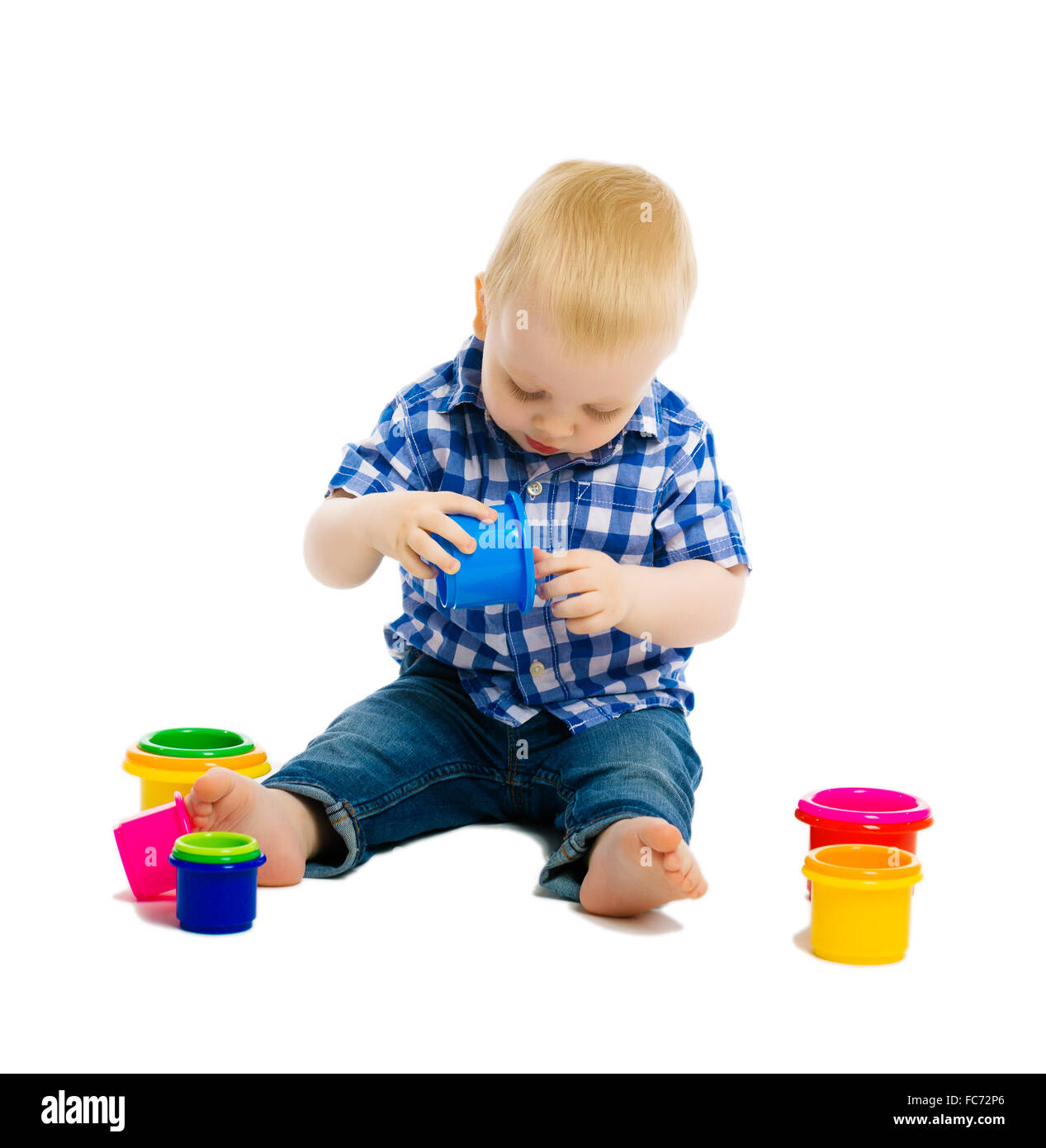 Baby boy playing with toys. isolated Stock Photo - Alamy