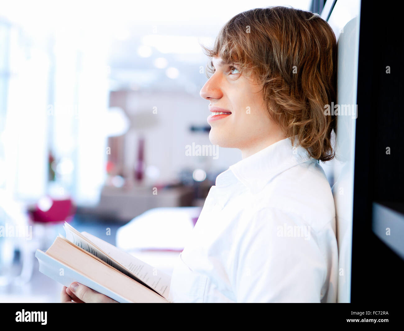 portrait of a young handsome man with a book Stock Photo - Alamy