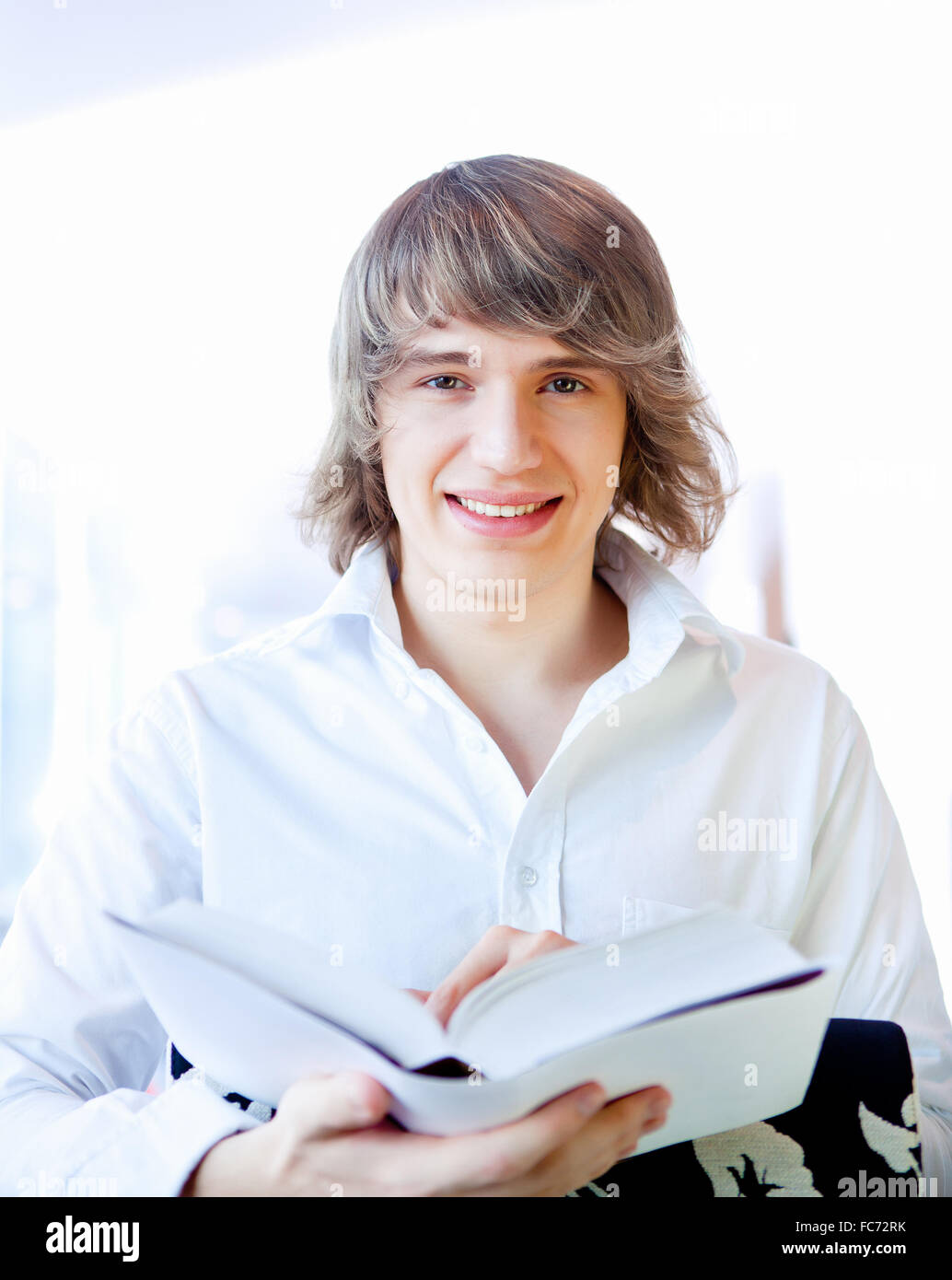 portrait of a young handsome man with a book Stock Photo - Alamy