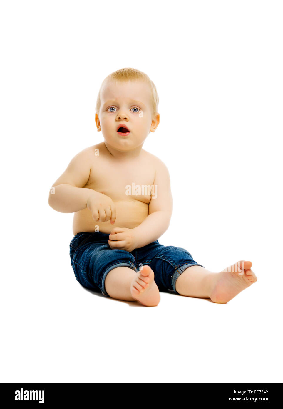 baby sitting on the floor. Studio. isolated Stock Photo - Alamy