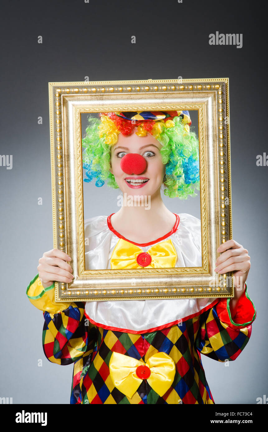 Clown with picture frame in funny concept Stock Photo - Alamy