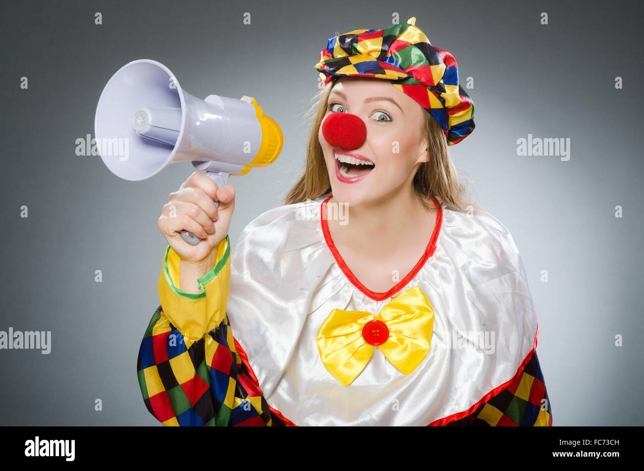 Clown with loudspeaker isolated on white Stock Photo - Alamy