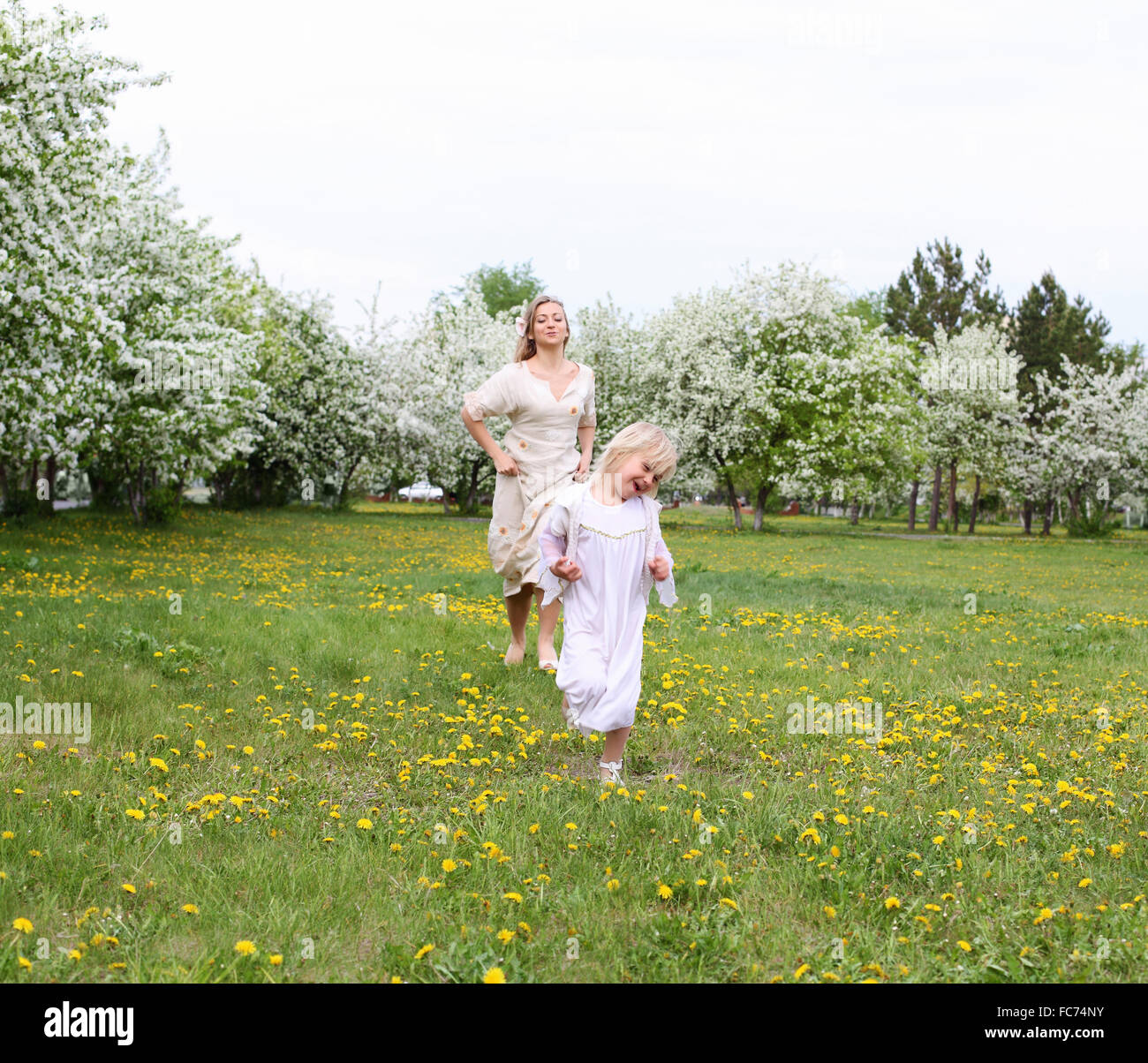 happy girl and her mother in the spring park Stock Photo - Alamy