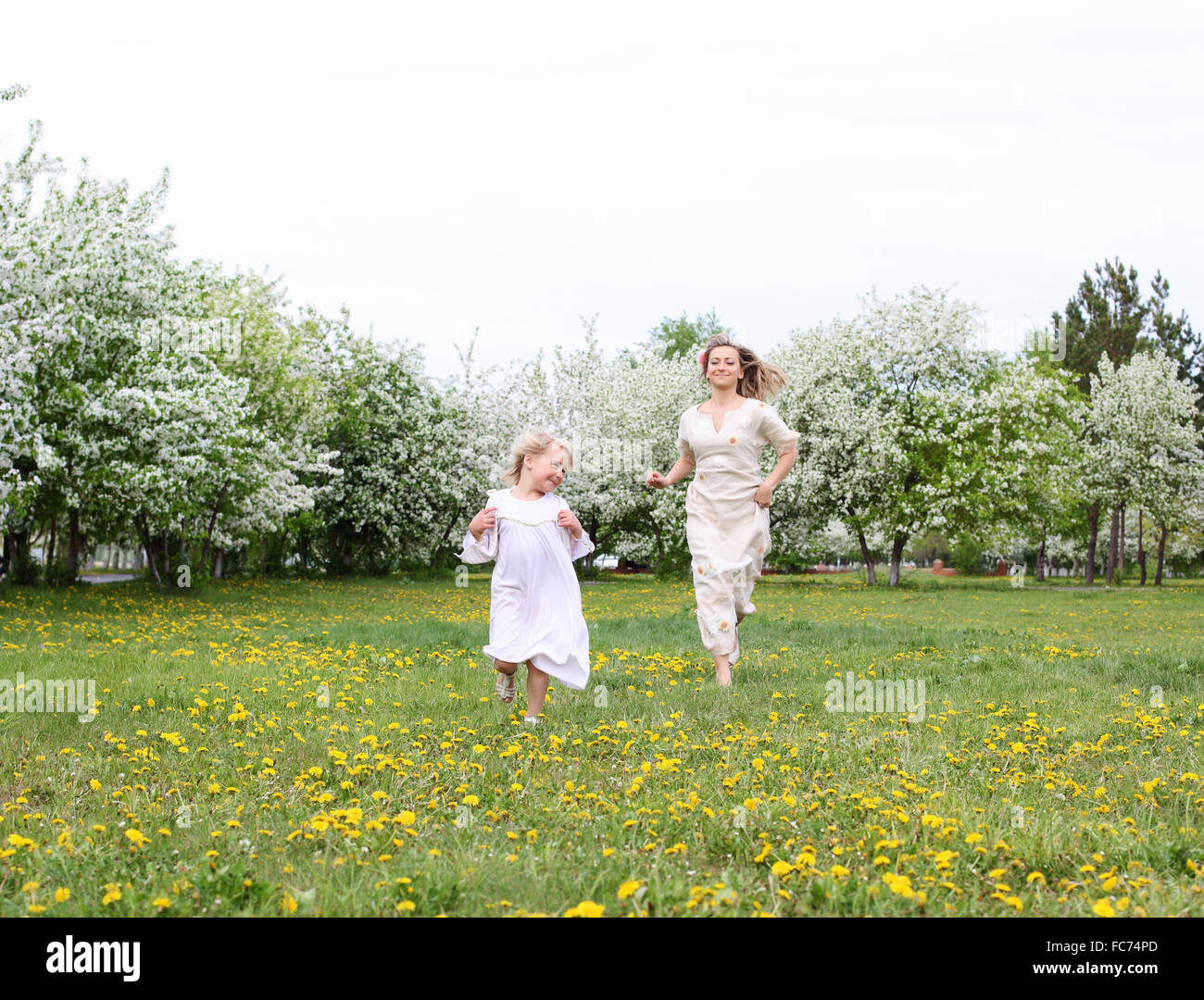happy girl and her mother in the spring park Stock Photo - Alamy