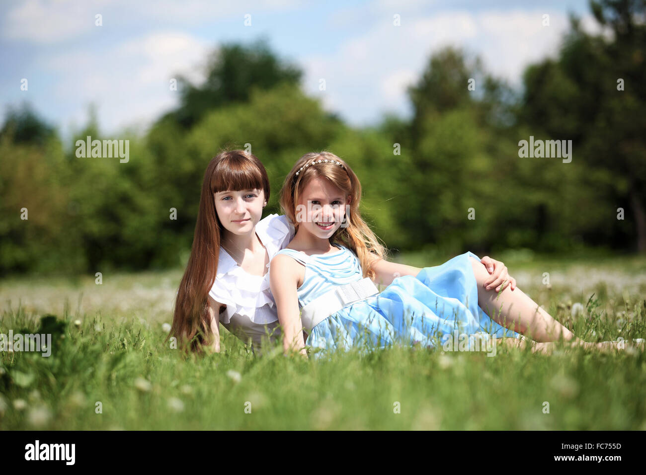 two girls spending time together in the summer park Stock Photo - Alamy