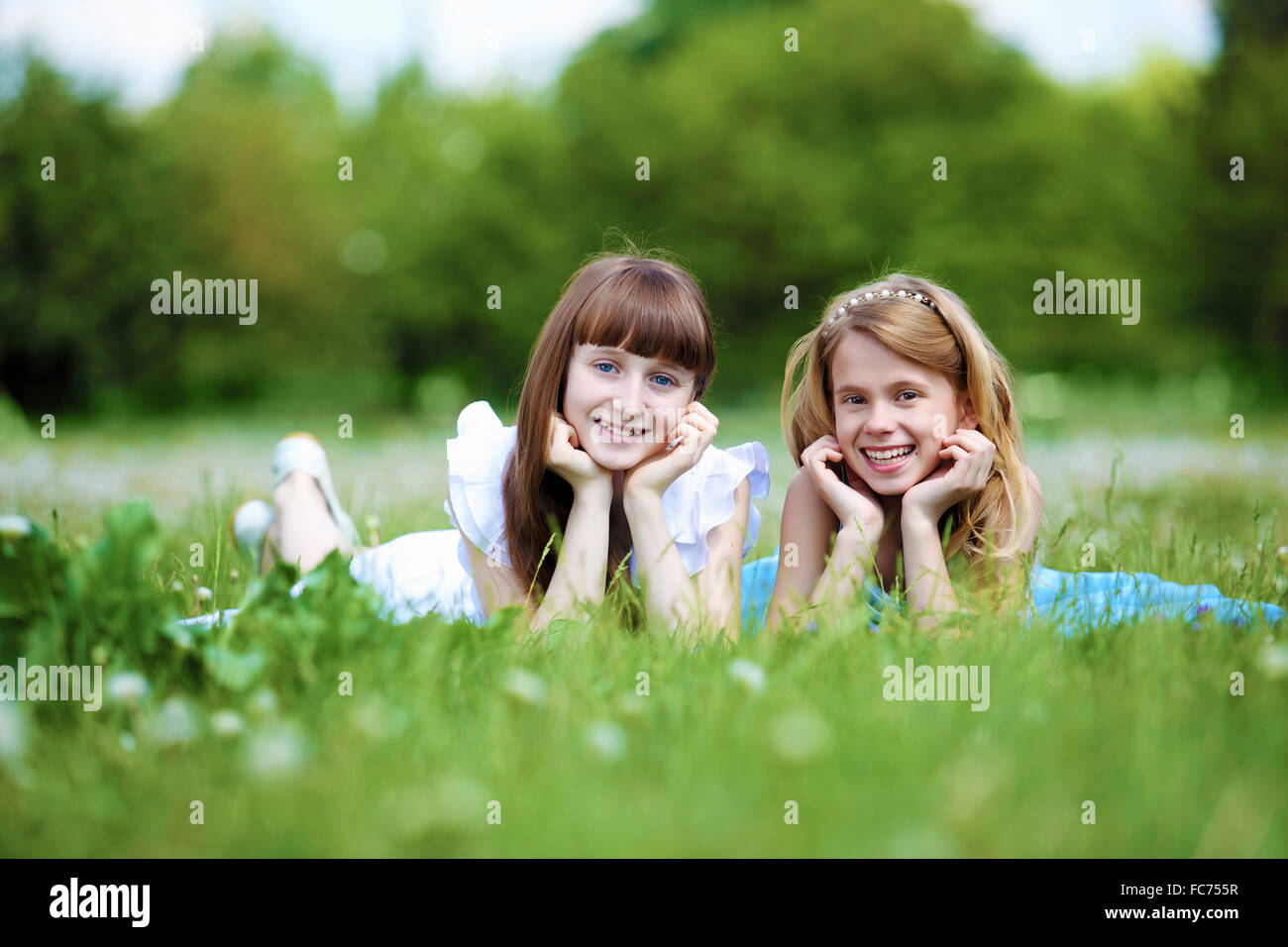 two girls spending time together in the summer park Stock Photo - Alamy