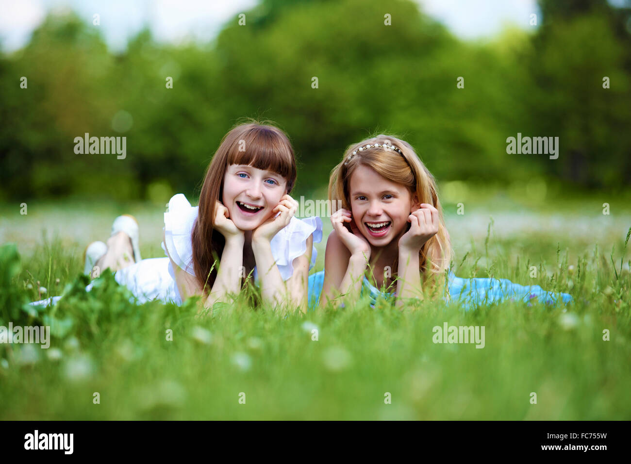 two girls spending time together in the summer park Stock Photo - Alamy