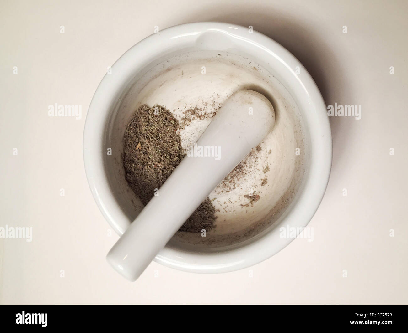 Herbs ground in mortar and pestle Stock Photo - Alamy