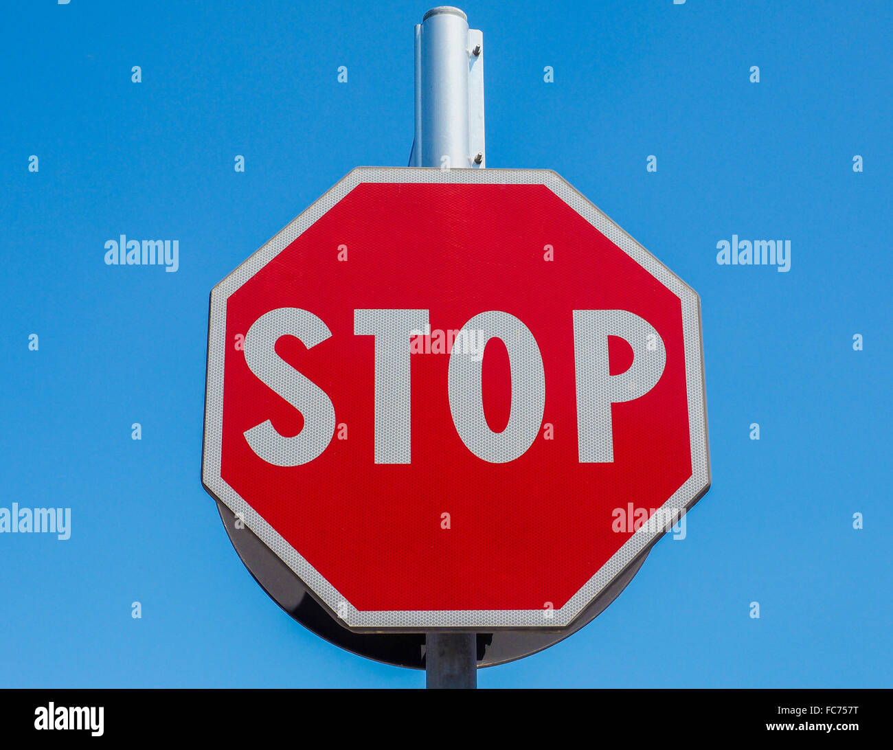 Stop sign over blue sky Stock Photo - Alamy