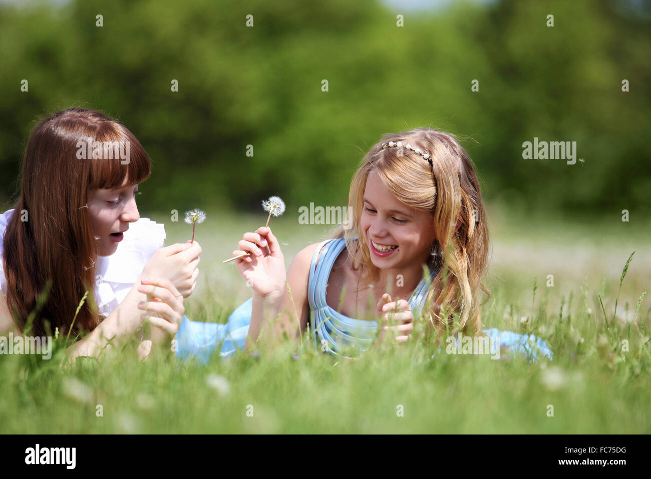 two girls spending time together in the summer park Stock Photo - Alamy
