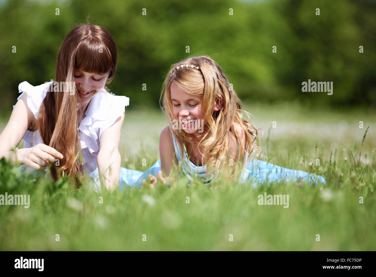 two girls spending time together in the summer park Stock Photo - Alamy