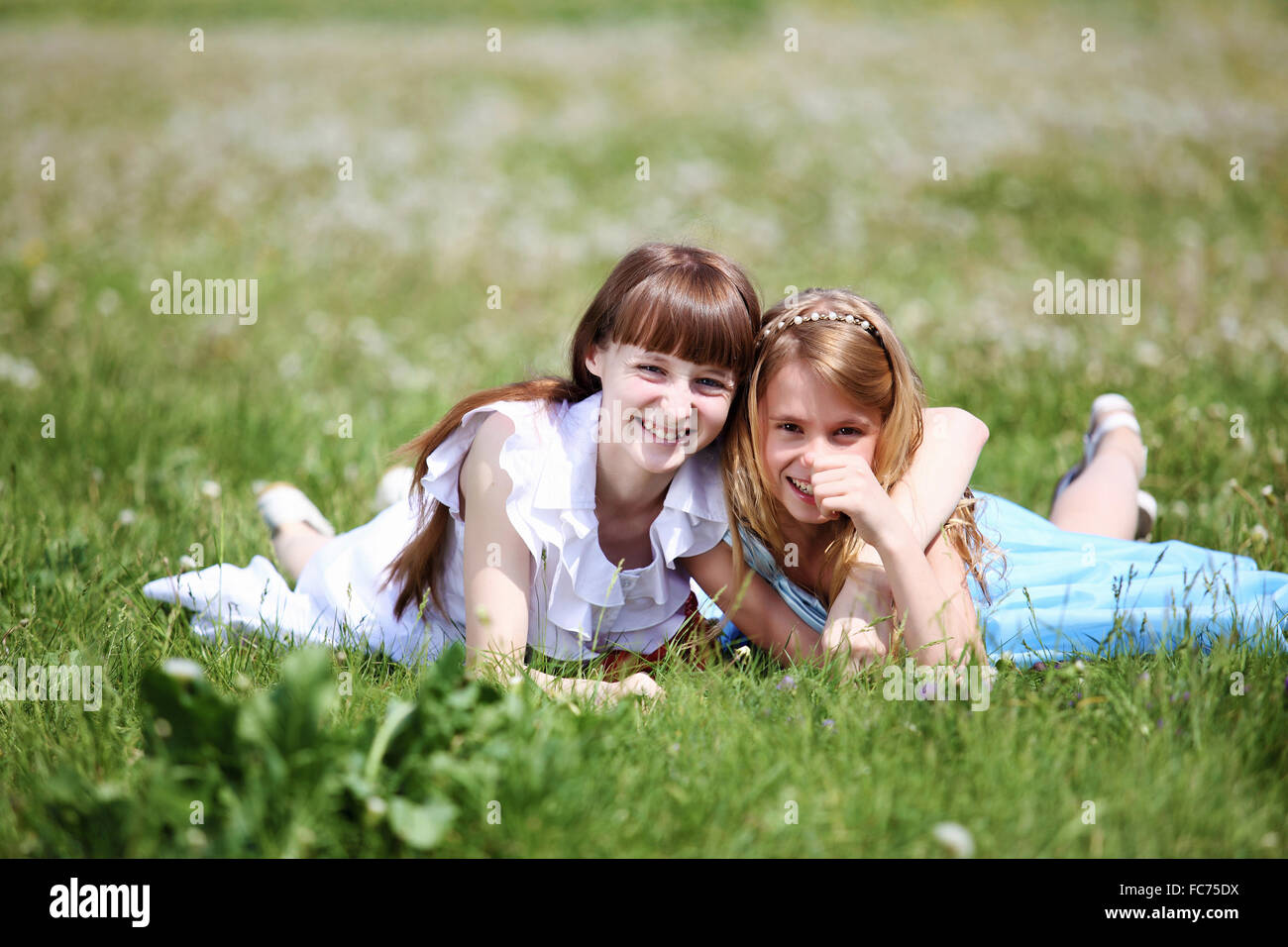 two girls spending time together in the summer park Stock Photo - Alamy