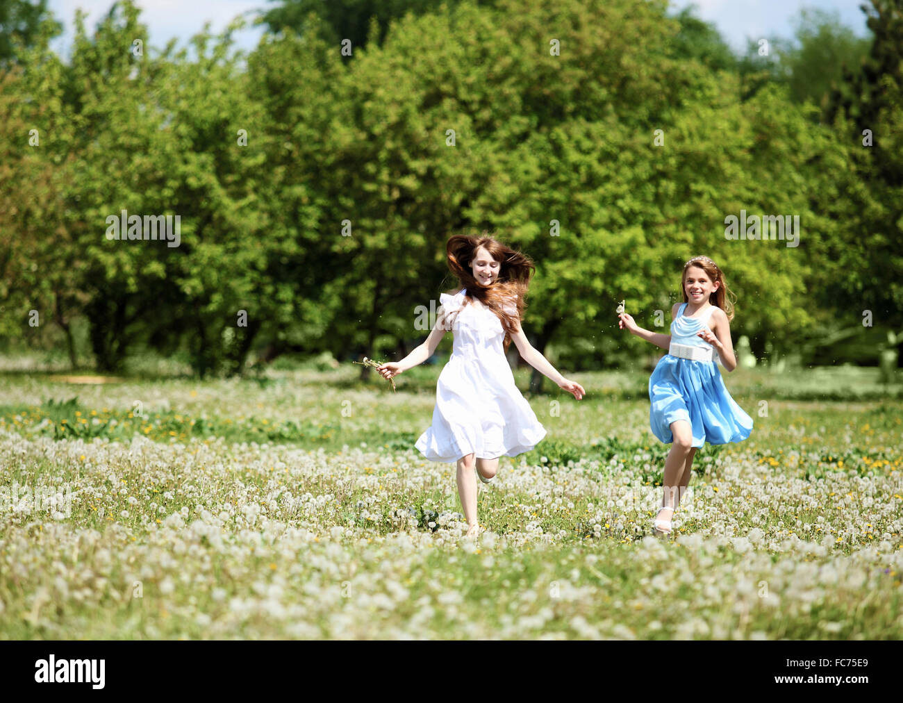 two girls spending time together in the summer park Stock Photo - Alamy