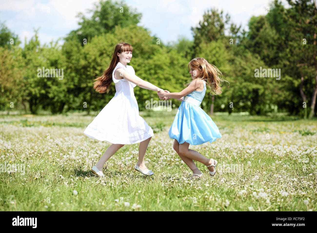 two girls spending time together in the summer park Stock Photo - Alamy