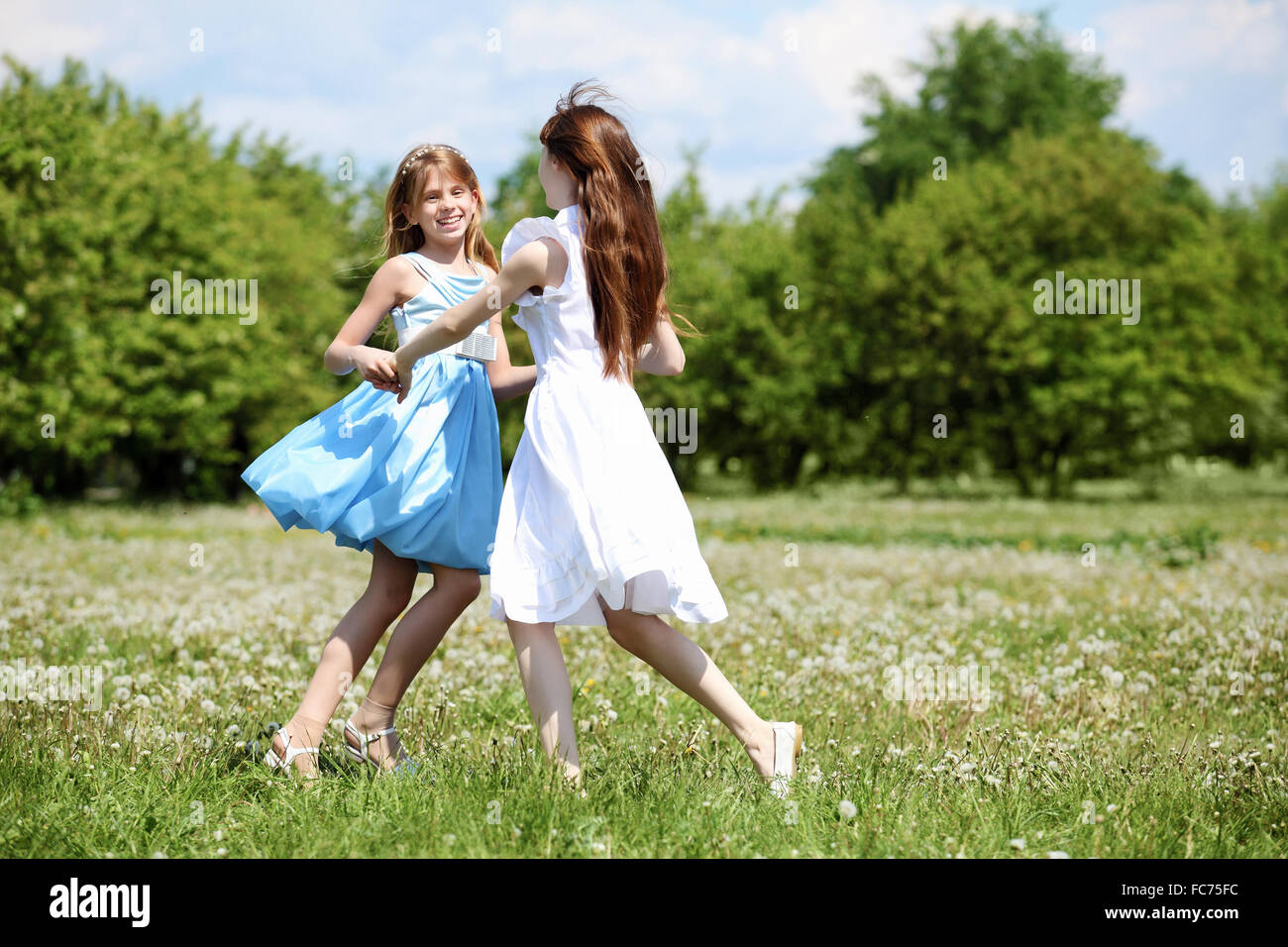 two girls spending time together in the summer park Stock Photo - Alamy
