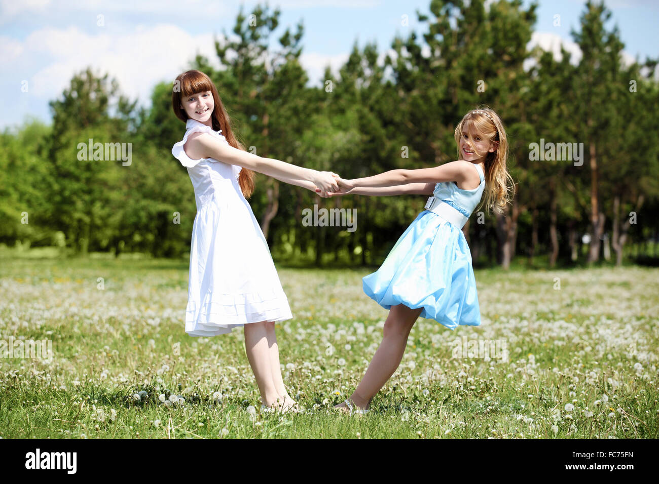 two girls spending time together in the summer park Stock Photo - Alamy