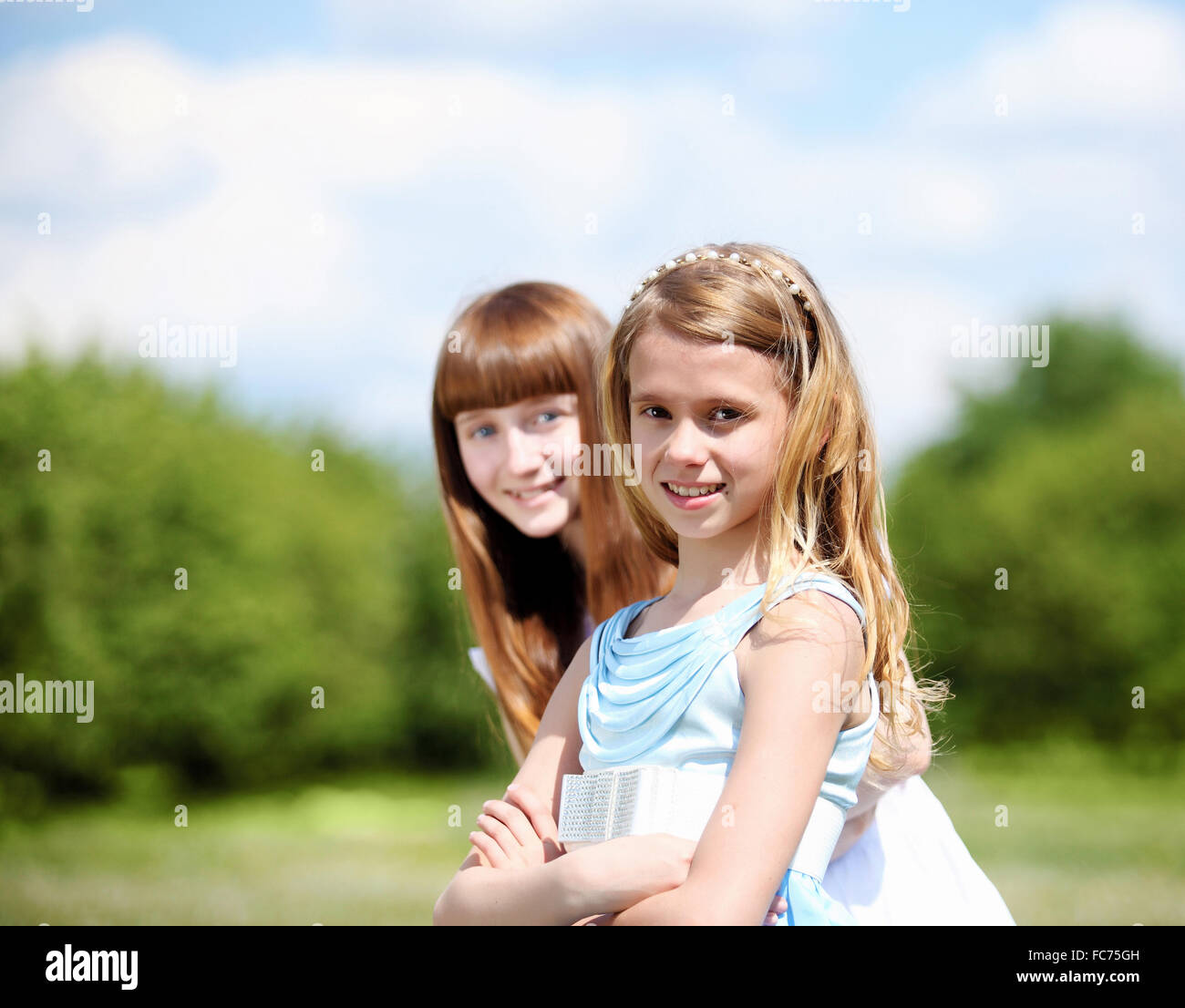 two girls spending time together in the summer park Stock Photo - Alamy