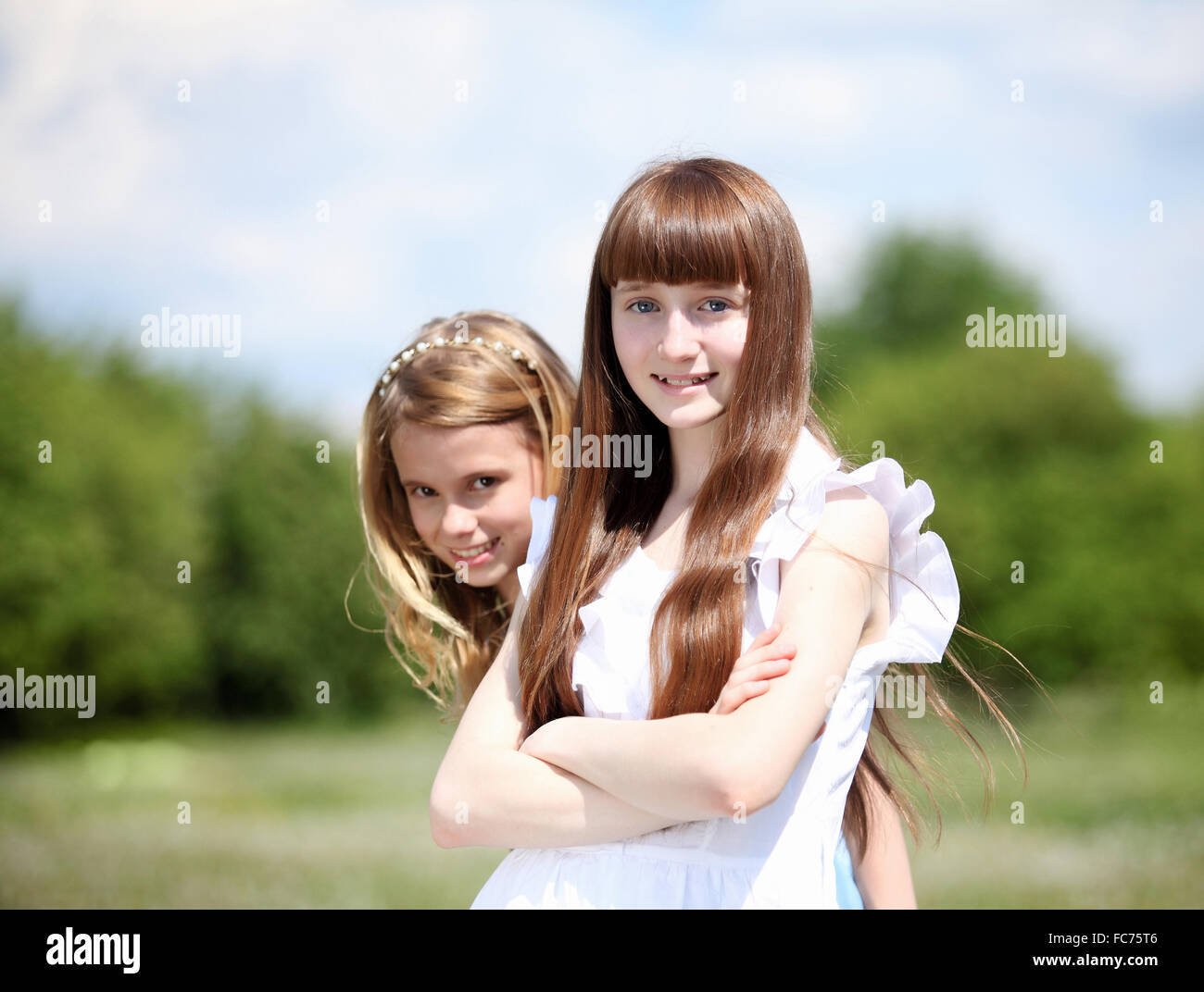 two girls spending time together in the summer park Stock Photo - Alamy