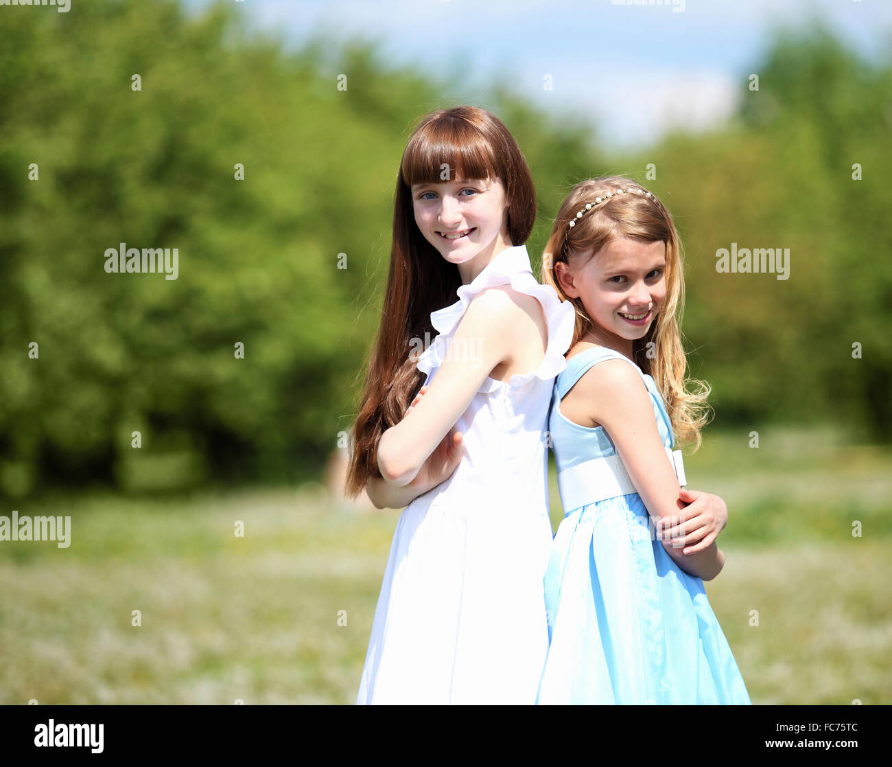 two girls spending time together in the summer park Stock Photo - Alamy