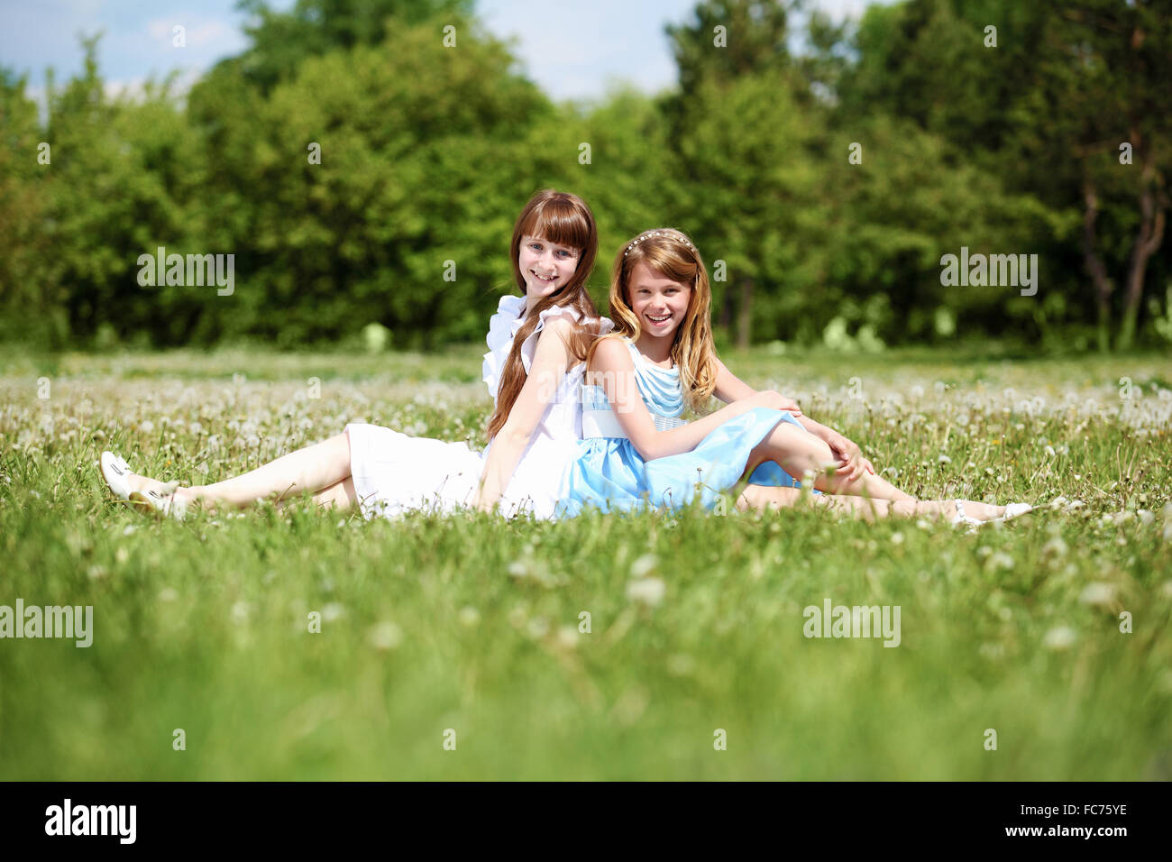 two girls spending time together in the summer park Stock Photo - Alamy