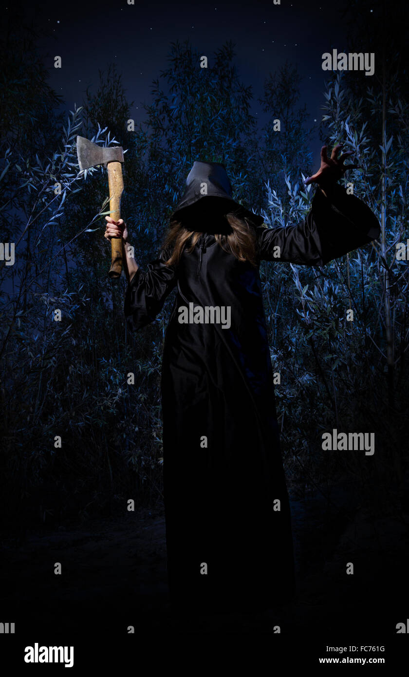 Woman with axe in forest Stock Photo - Alamy