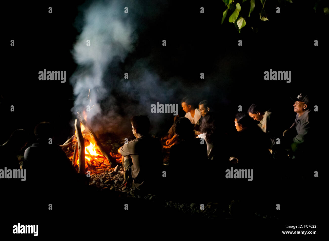 Young men, including movie star Nicholas Saputra, are sitting with ...