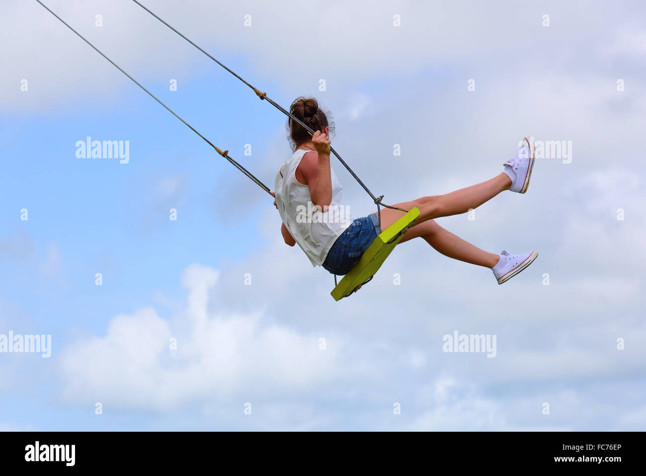 Woman swinging high Stock Photo - Alamy