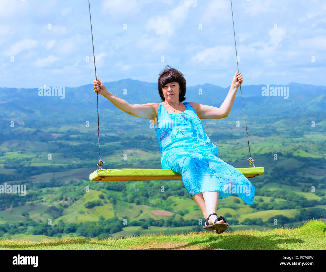 Woman swinging high Stock Photo - Alamy