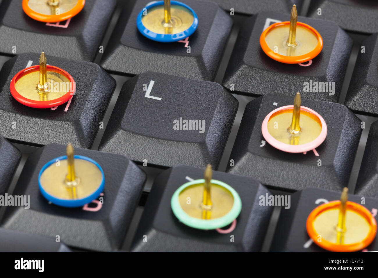 Pins on computer keyboard Stock Photo - Alamy