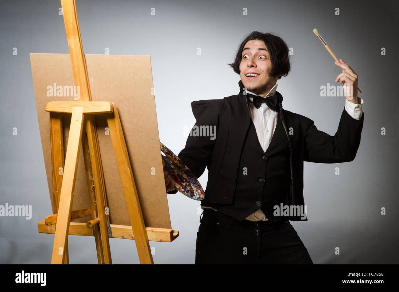 Funny artist in dark studio Stock Photo - Alamy