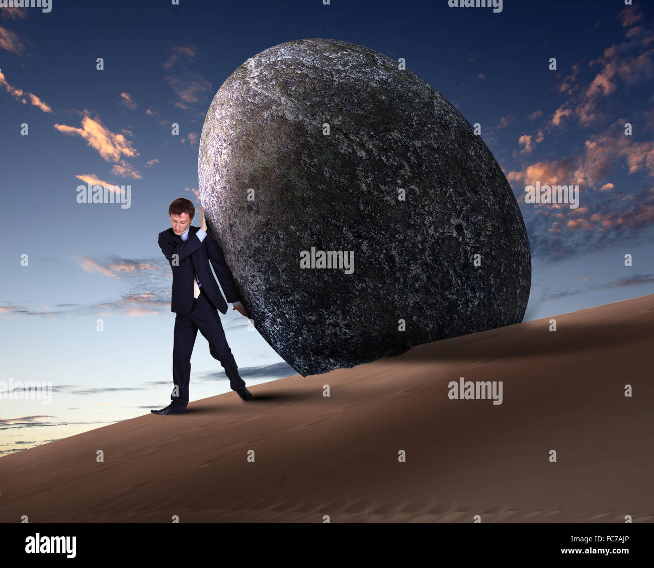 Image of businessman rolling a giant stone Stock Photo - Alamy