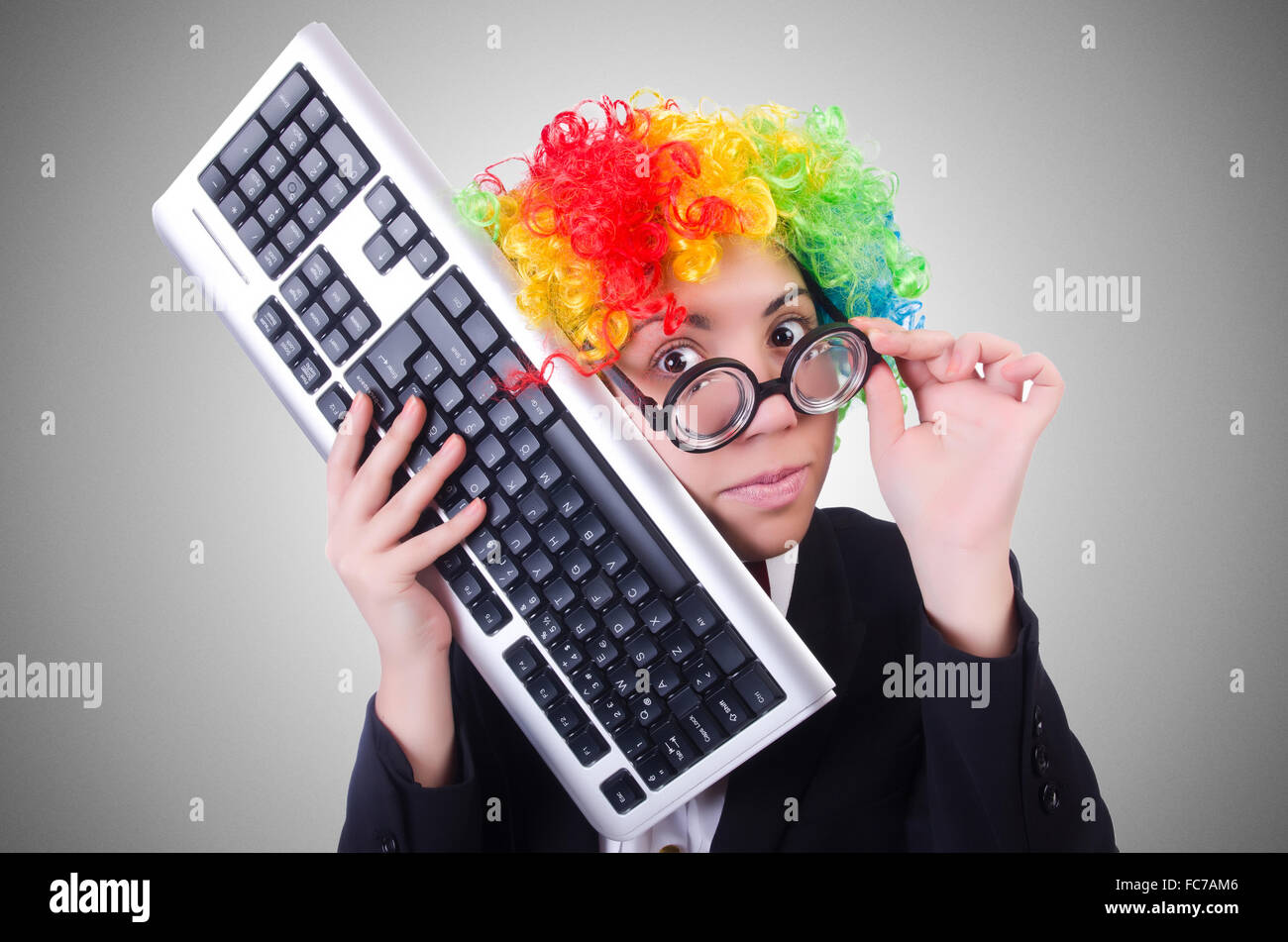 Funny clown with keyboard on white Stock Photo - Alamy