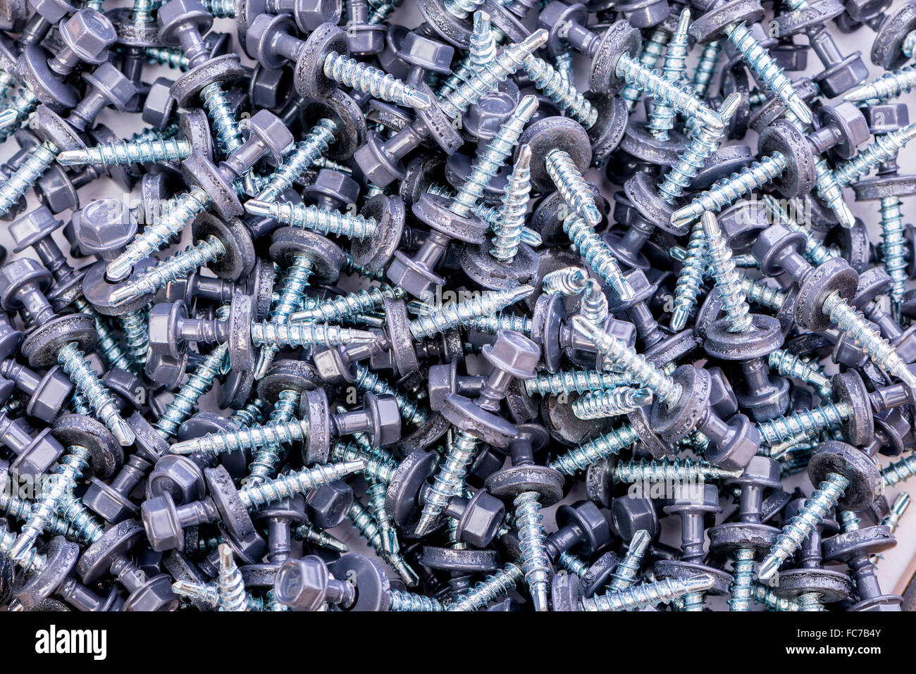 Many screws arranged as background Stock Photo - Alamy