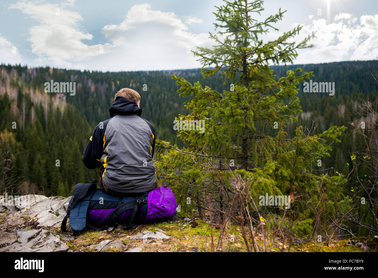 Caucasian hiker sitting on remote hilltop Stock Photo - Alamy