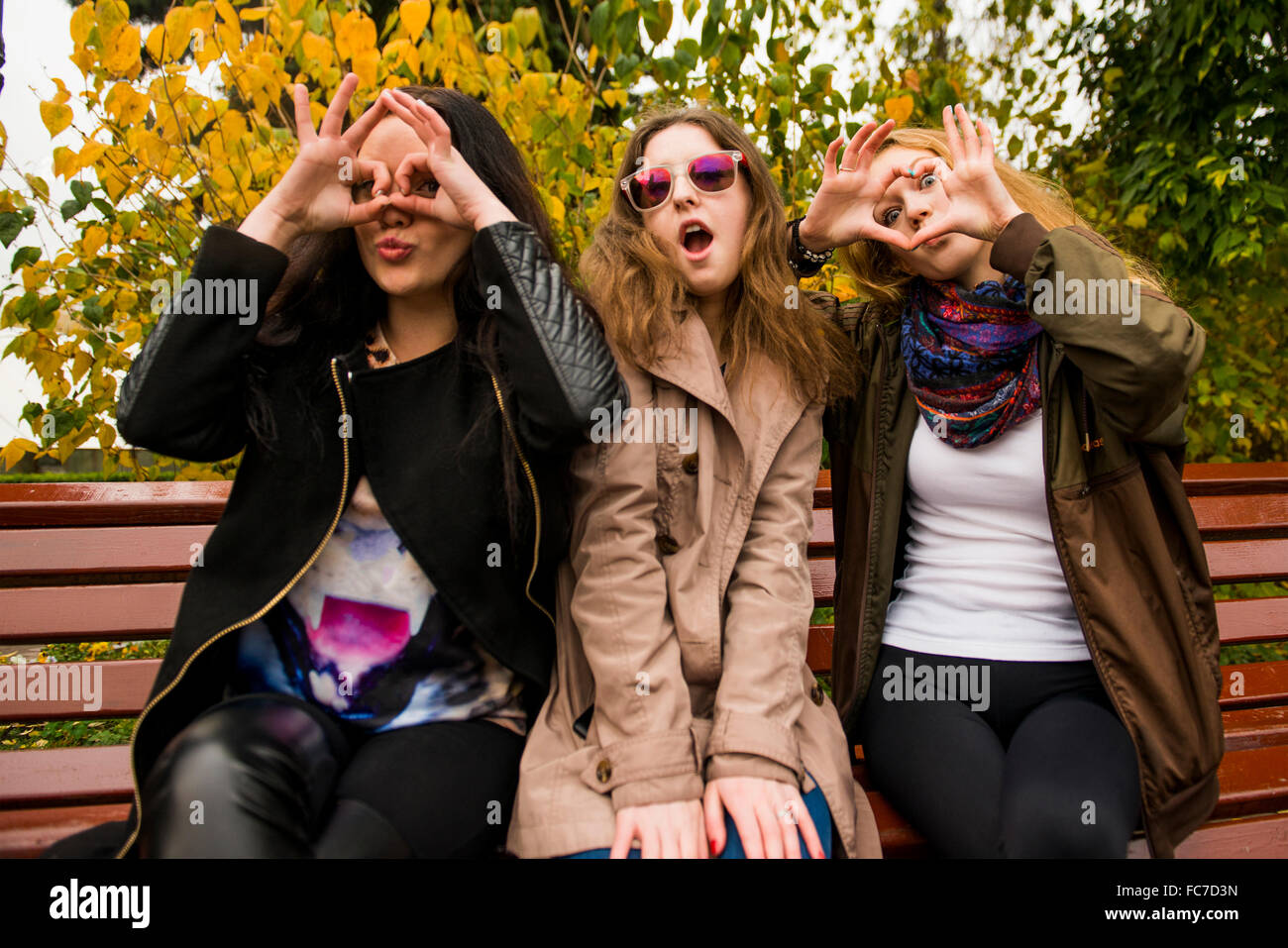 Caucasian women posing on bench Stock Photo - Alamy